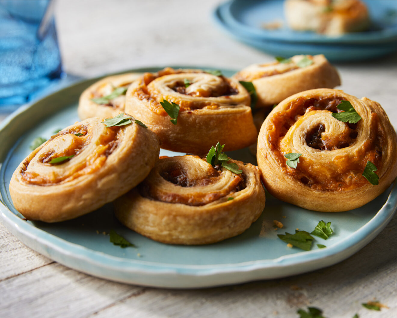 Caramelized Onion and Cheddar Pinwheels - Fifty-Five Plus Magazine